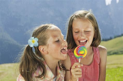 Italy South Tyrol Two Girls 6 7 10 11 Licking Lollypop Portrait