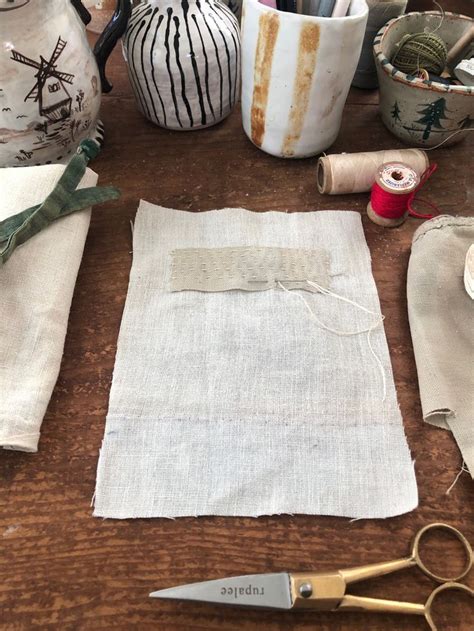 The Table Is Covered With Fabric And Other Crafting Supplies Such As
