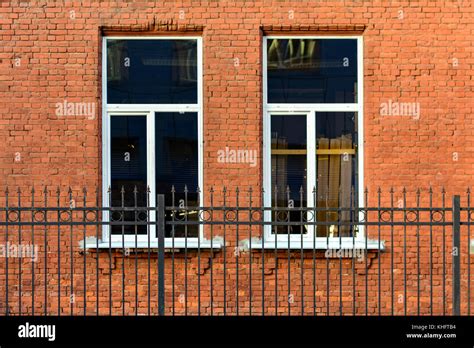 Two Rectangular Windows With White Frame On A Background Of Wall Of