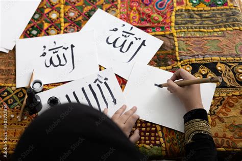 Close Up Muslim Girl Hands Writing Arabic Text With Bamboo Pens And