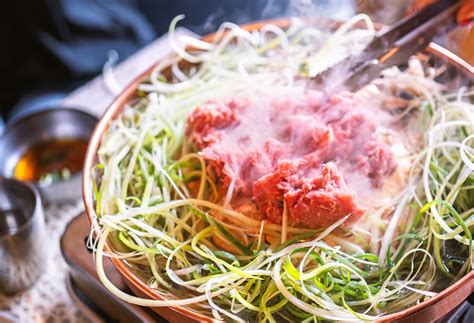서울에 있는 한국 레스토랑에서 쇠고기 바베 큐 불고기 라이프 스타일 신선한 한국 음식 요리 구리 냄비에 얇게 썬 그릴 클로즈업