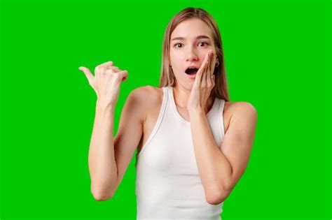Premium Photo Surprised Woman Pointing Offscreen Against Green Screen