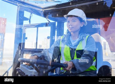Supply Chain Logistics And Transport With A Woman Shipping Worker Driving A Vehicle On A