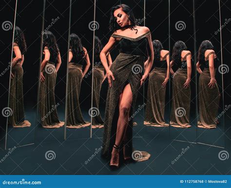 Portrait Of Beautiful Brunette Woman Standing Near The Mirrors Stock
