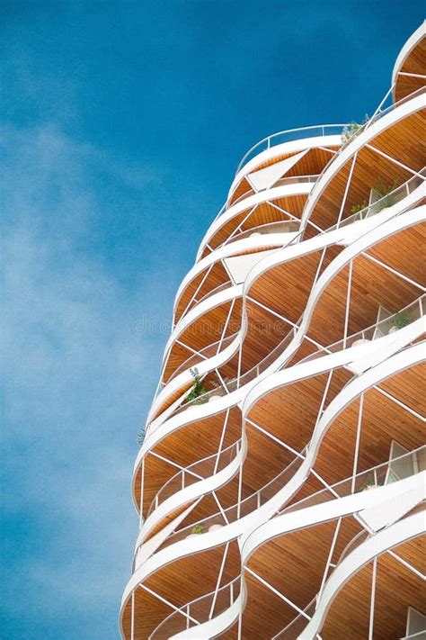 Vertical Closeup Of A Modern Apartment Building With Wavy Balconies