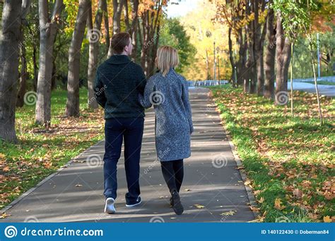 Romantic Couple Relaxing In Autumn Park Cuddling Enjoying Fresh Air