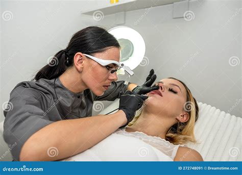 Feamle Doctor Cosmetologist Doing Medical Procedure With