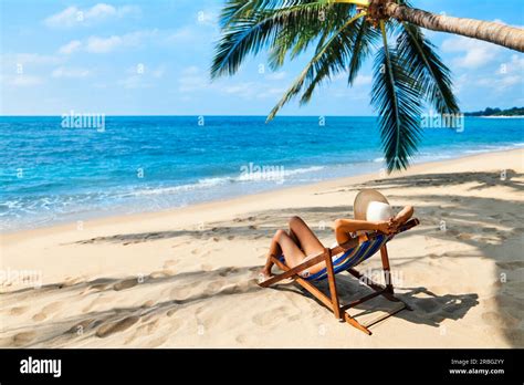 Back View Of Young Beautiful Woman Sunbathe And Relax On Tropical Beach