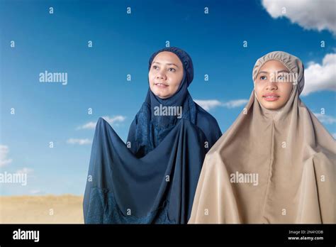 Asian Muslim Mother And Daughter In A Hijab Raised Hands And Praying