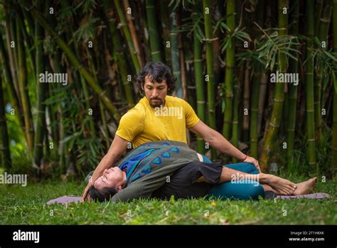 Thai Massage Therapy Session Outdoors With Bamboo Background Man And