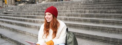 Premium Photo Outdoor Shot Of Young Stylish Redhead Girl Sits On