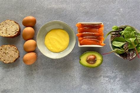An Assortment Of Food Including Eggs Salmon And Avocado On A Gray Surface