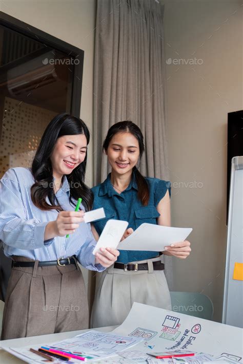 Ux Developer And Ui Designer Presenting Mobile App Interface Design On Whiteboard In Meeting At