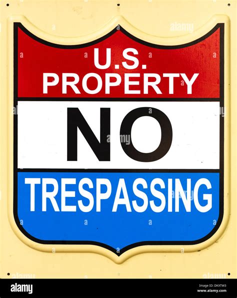 Us Property No Trespassing Sign On The Side Of A Federal Building In