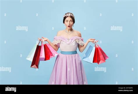Shocked Princess Young Woman In Image Of Young Queen Holding Bright Shopping Packages Looking