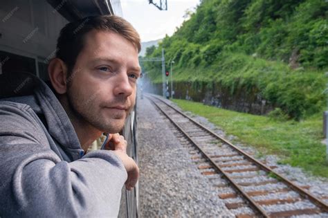Premium Photo Young Man Looking Out Of Train Window While Traveling