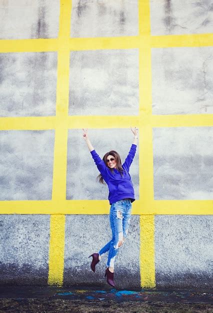Premium Photo Woman In Sunglasses Jumping Up