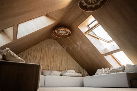 Cozy Attic Living Space With Wooden Interior And Natural Light From