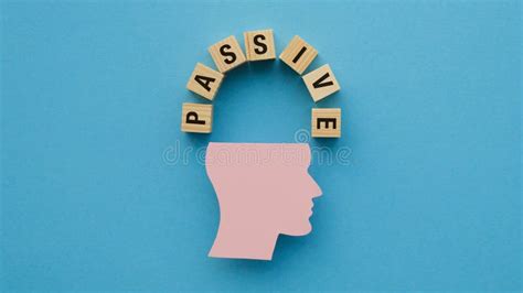 Passive Text On Wooden Cubes Over A Paper Figure Of A Human Head The