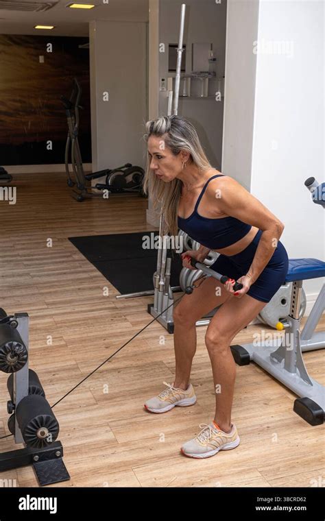 46 Year Old Brazilian Woman Doing Back Exercises On The Pulley Machine