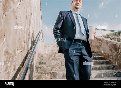 Confident Middle Age Businessman With Briefcase Walking Upstairs Close