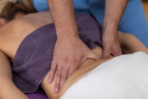 A Physical Therapist Provides A Sports Massage On An Athletes Back To