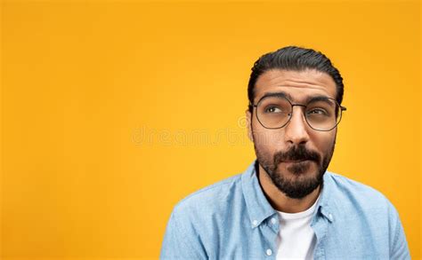 Pensive Indian Millennial Man In Glasses Look At Free Space Think