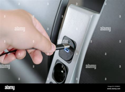 Crop Unrecognizable Male Inserting Black Charging Cable Connector Plug Into Usb Charging Port