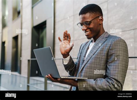 Handsome Smiling Smart African Man Wearing Suit Using Laptop Computer