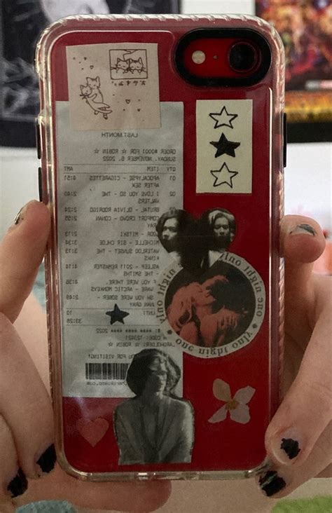 A Person Holding Up A Cell Phone Case With Stickers On It S Side
