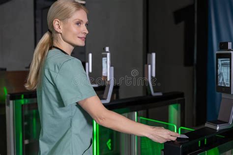 Female Doctor Lab Coat Passing Security Control Using Access Card Stock