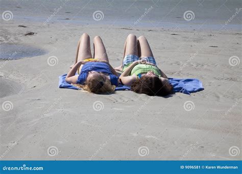 Two Teenage Girls Sunbathing At The Beach Stock Image Image Of Sand