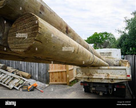 Treated Retaining Posts On The Truck Parked On The Narrow Driveway