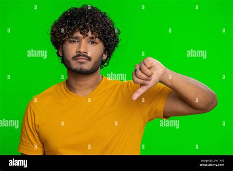 Dislike Upset Unhappy Indian Man In Shirt Showing Thumbs Down Sign