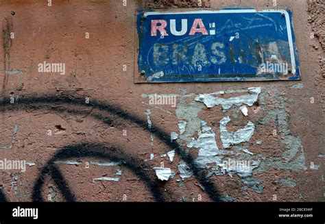 Crumbling Paintwork And Graffiti Disfigure A Street Sign In Rocinha