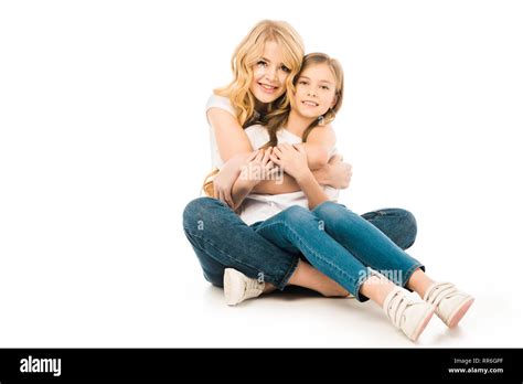 Happy Mother And Cute Daughter Hugging While Sitting On Floor With