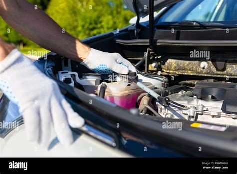 Driver Check The Coolant Level In The Engine Compartment Of The Car Car Coolant Expansion Tank