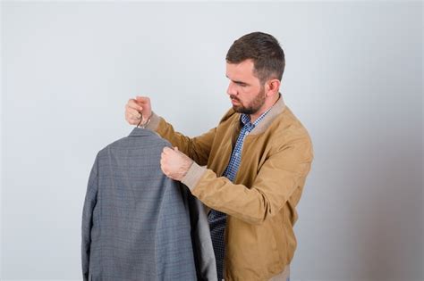 Free Photo Young Man In Jacket Shirt Looking At Suit Standing