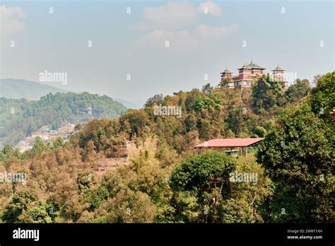 Tibetan Temple On Mountain Shrouded In Green Vegetation Amidst Peaceful