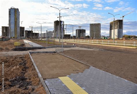 Laying Paving Slabs And Borders At Construction Site Process Of Installing Paving Bricks In The