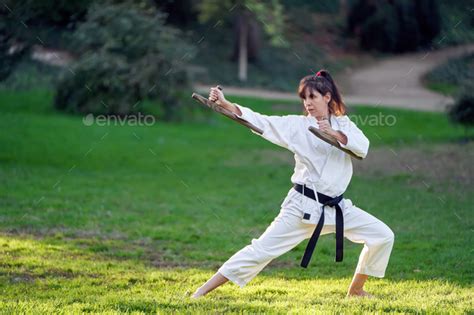 Karate Fighter Woman In Kimono And Black Belt Standing In Karate Pose