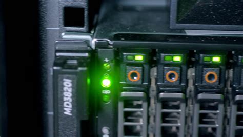 Green LED Lights On Multiple Hard Drives Of A Large Server Blink On And Off In A Rotating