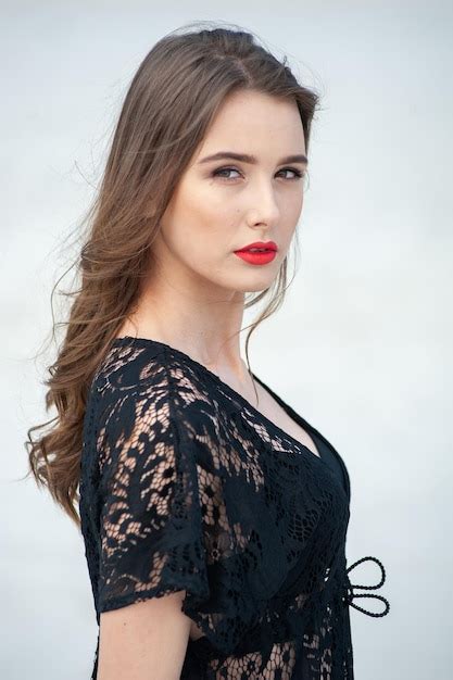 Premium Photo A Woman In A Black Dress With Red Lipstick And A Red