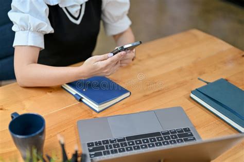 Close Up Image Of A Businesswoman Using Her Smartphone At Her Desk