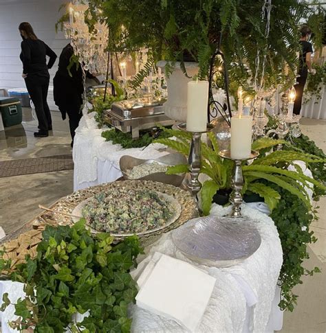 An Assortment Of Food Is On Display In A Room With White Linens And