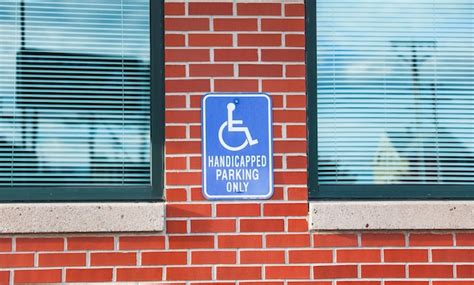 Premium Photo Wheelchair Accessibility Sign Against A Vibrant Urban Backdrop Symbolizing