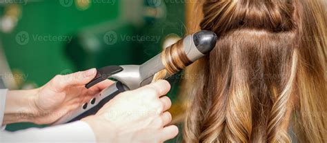Creating Curls With Curling Irons Hairdresser Makes A Hairstyle For A