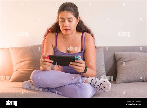 Venezuelan Latin Adult Female Gaming Portable Video Game Holding Joystick Controller Stock