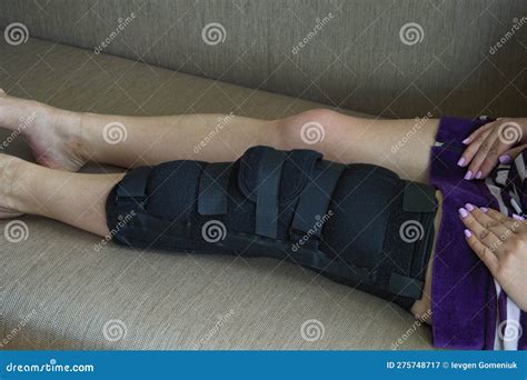 A Man With A Broken Leg In An Orthosis On A Bed In A Clinic After An