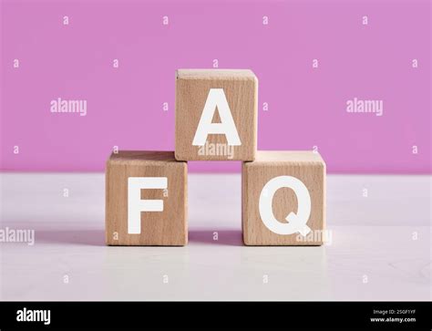 Three Wooden Cubes With White Letters Forming The Acronym Faq